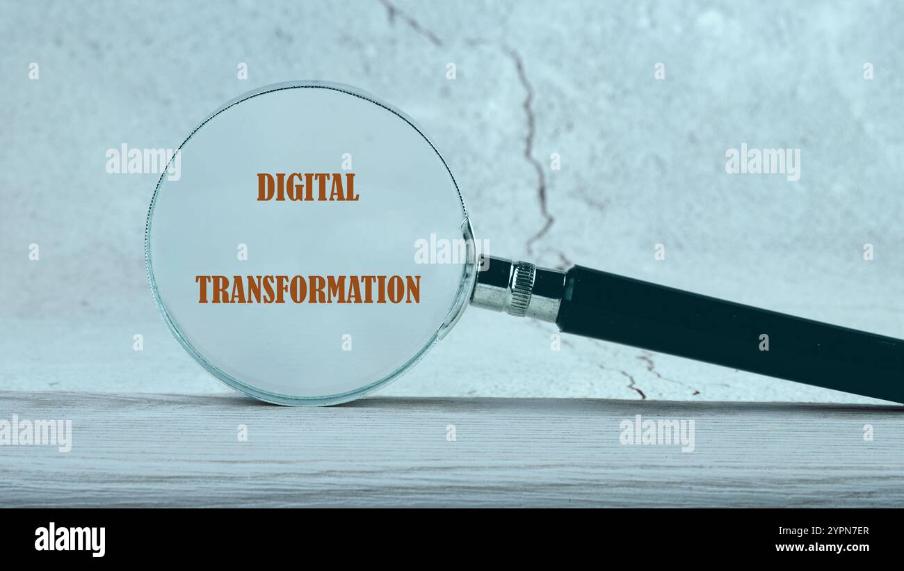 DIGITAL TRANSFORMATION word concept written through a magnifying glass ...