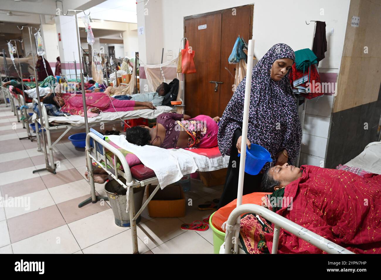 Patients suffering from dengue fever receive treatment inside the ...