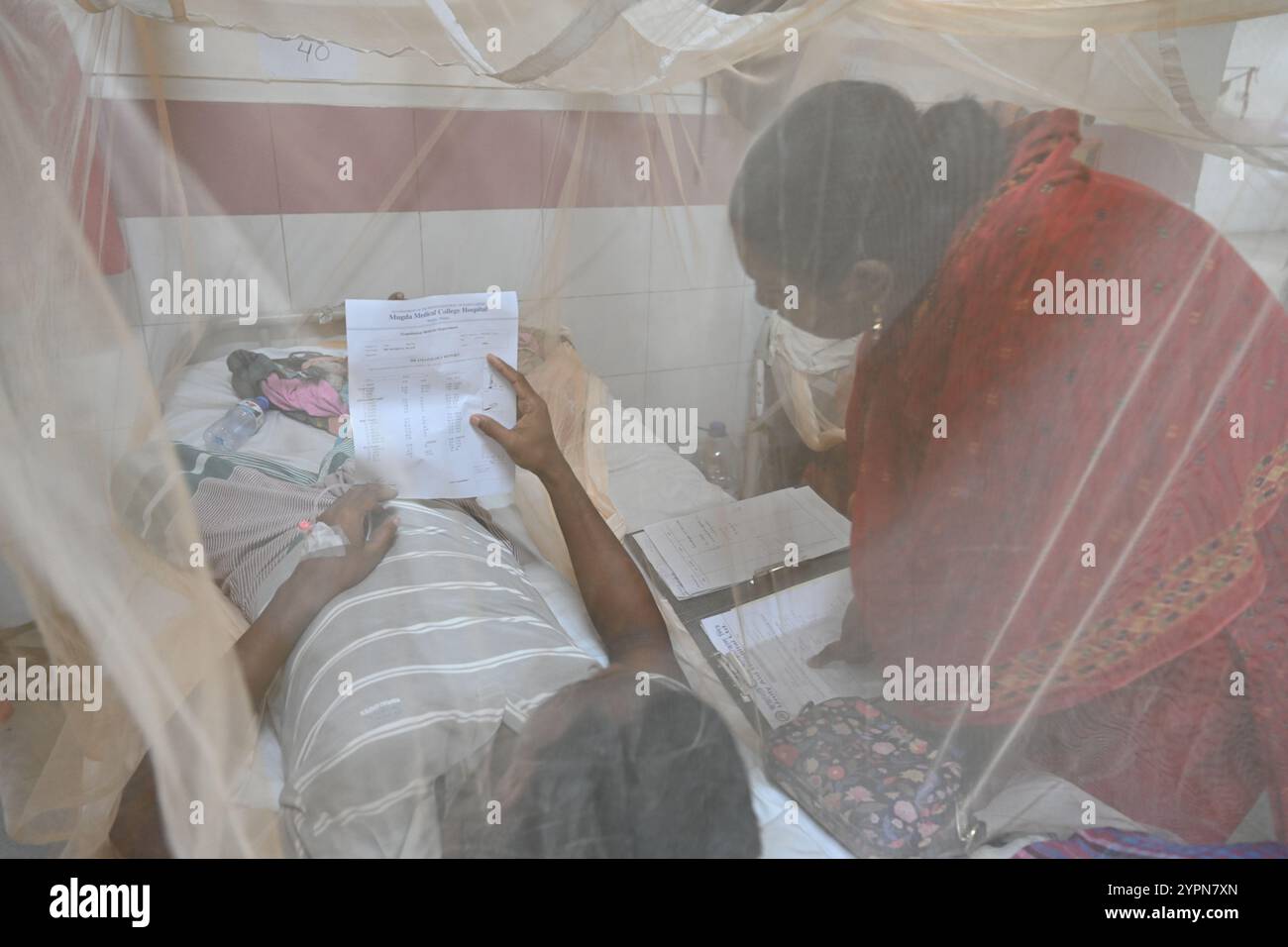 Patients suffering from dengue fever receive treatment inside the ...