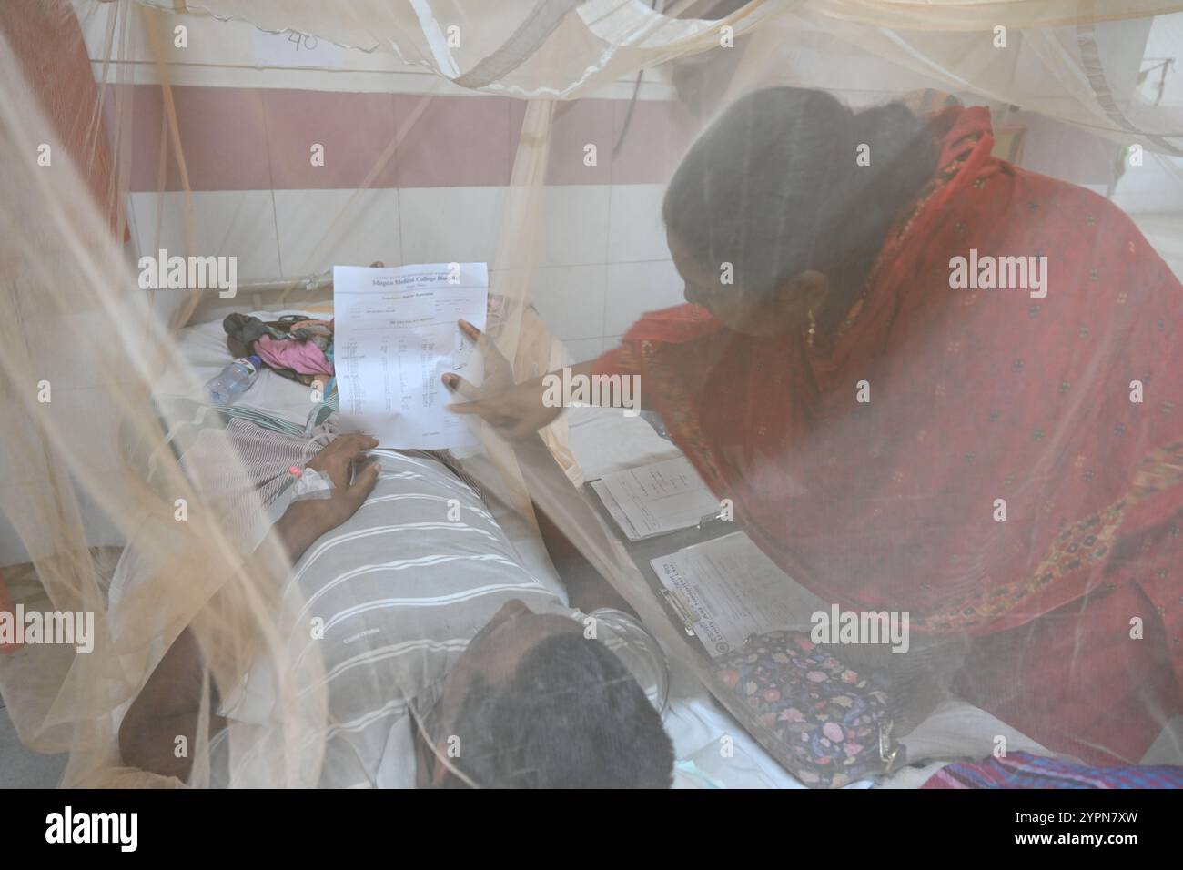 Patients suffering from dengue fever receive treatment inside the ...