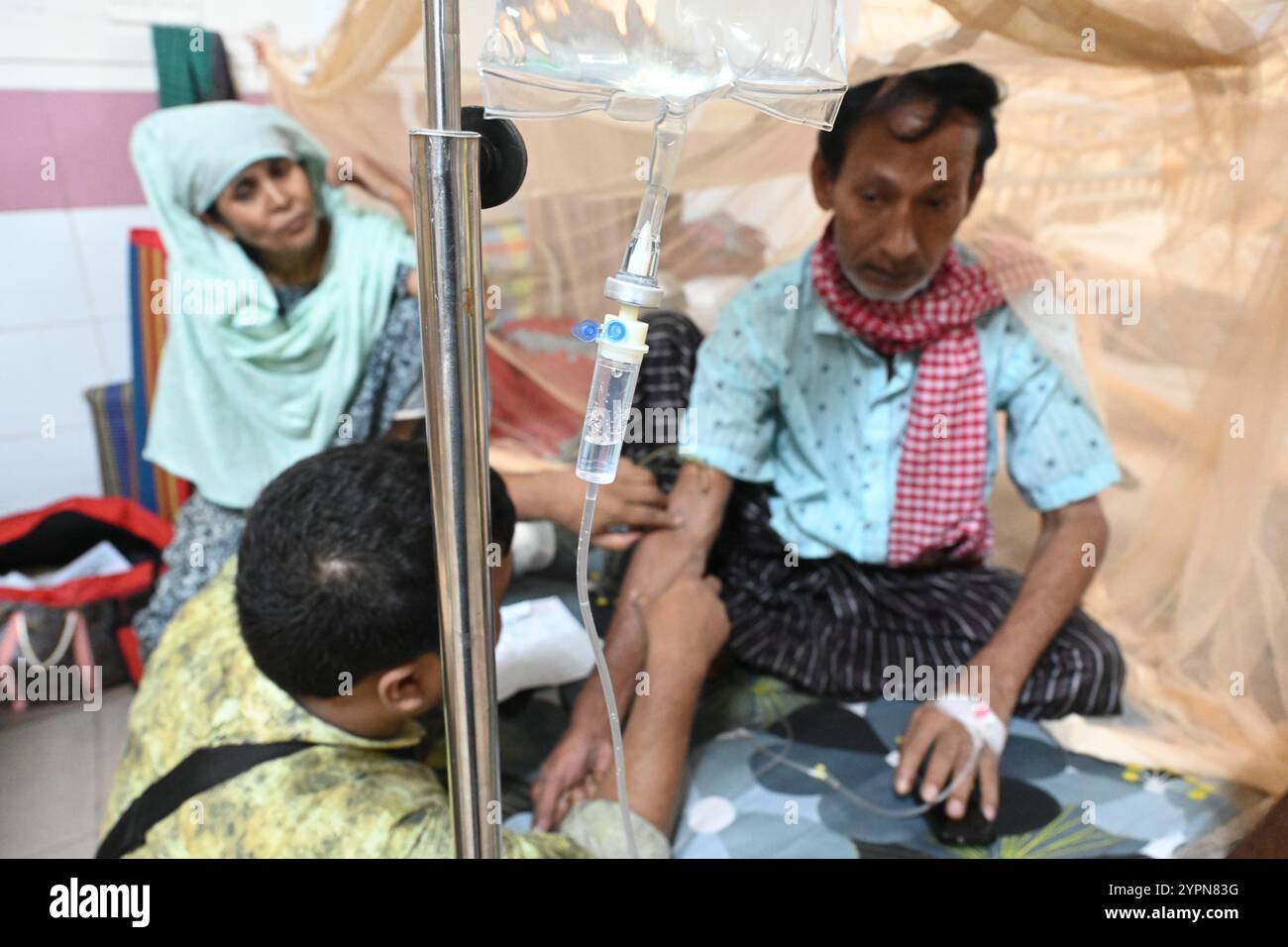 Patients suffering from dengue fever receive treatment inside the ...