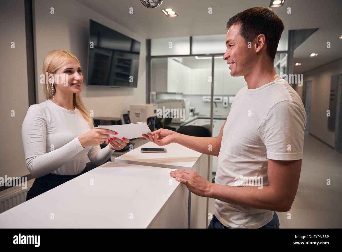 Receptionist giving medical insurance hi-res stock photography and ...