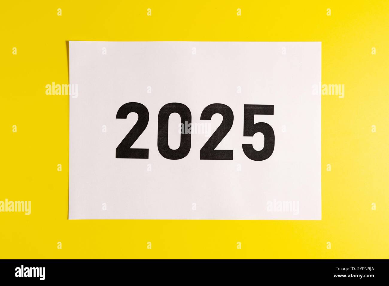 White sheet of paper with the inscription 2025 on a yellow background ...
