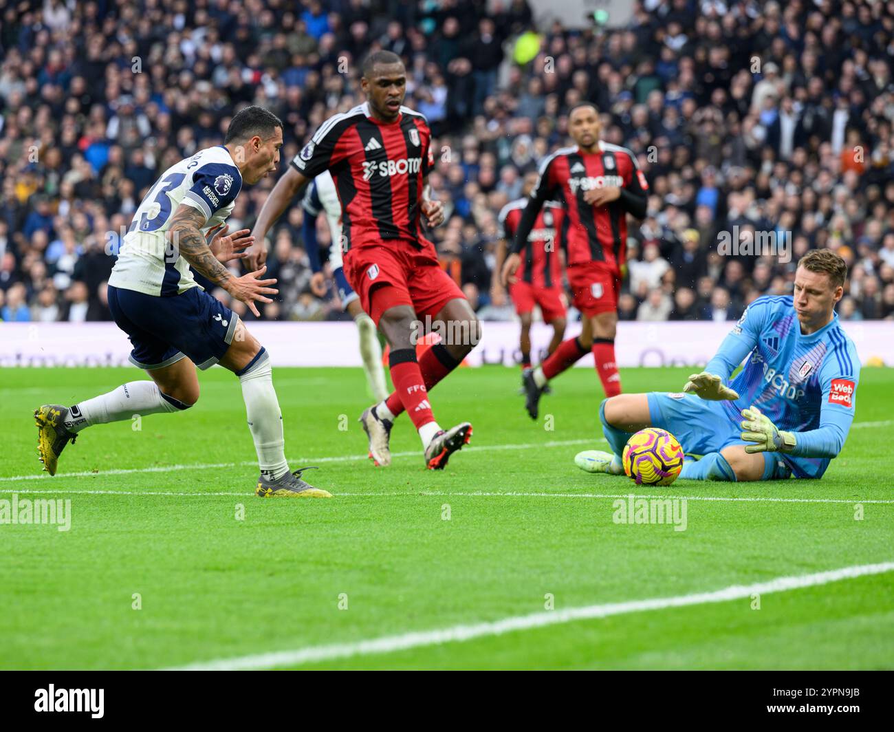 London, England - 2024 December 1st: Fulham's Bernd Leno (right) under pressure from Tottenham ...
