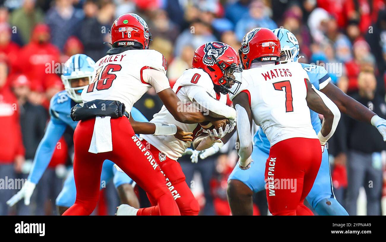 November 30, 2024: NC State freshman CJ Bailey (16) hands ball to NC ...