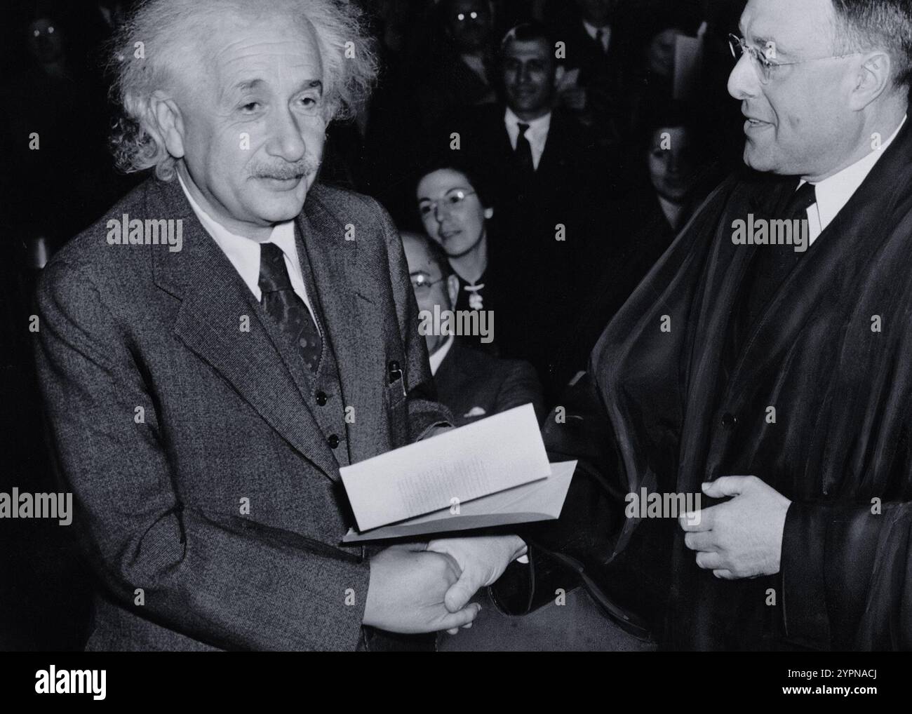 Albert Einstein in 1940 receiving from Judge Phillip Forman his ...