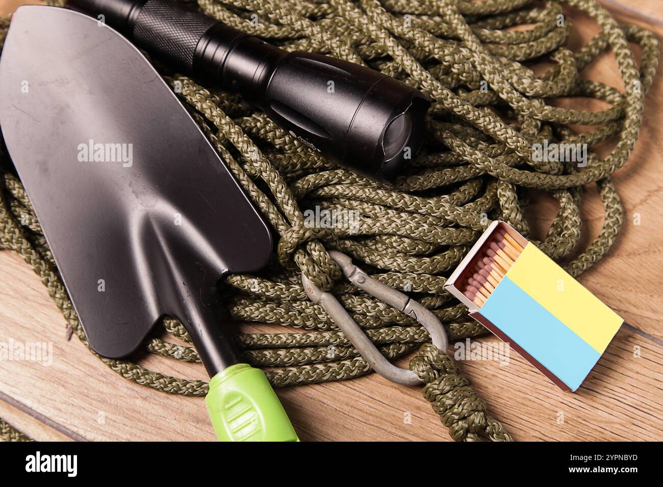 Survival Kit. Khaki Rope, Matches, Shovel, Black flashlight, Survival ...