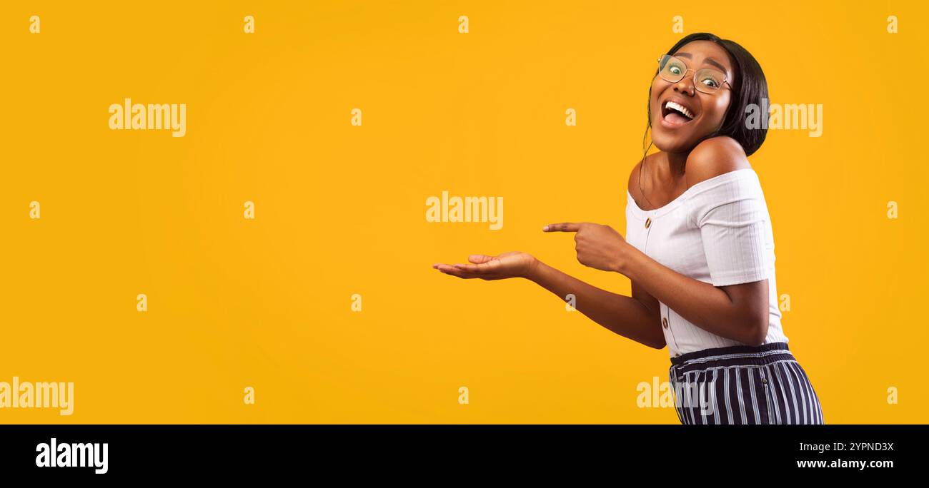 Girl Pointing Finger At Open Palm Standing, Studio Shot, Panorama Stock ...