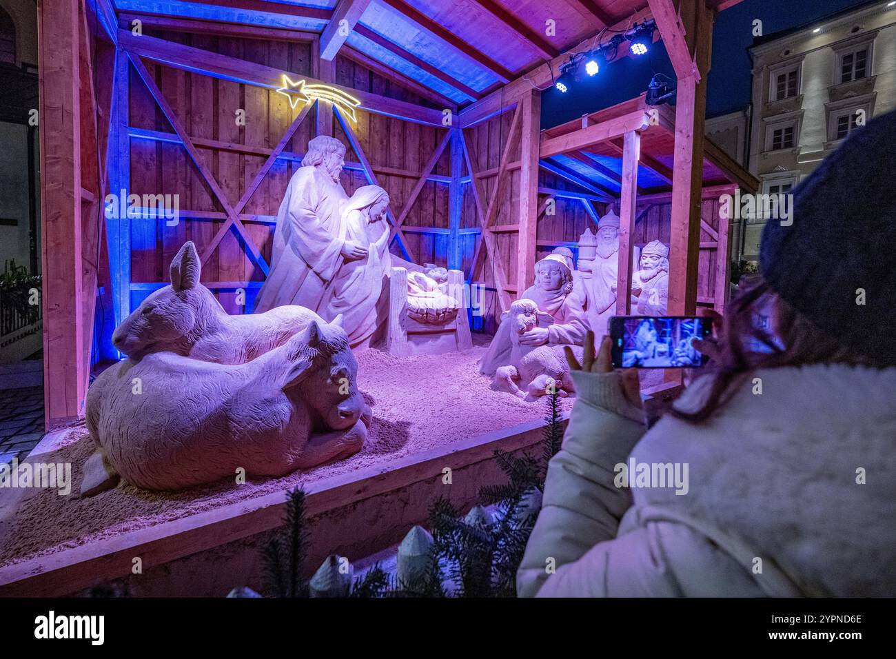 01 December 2024, Bavaria, Deggendorf: A woman photographs the largest ...