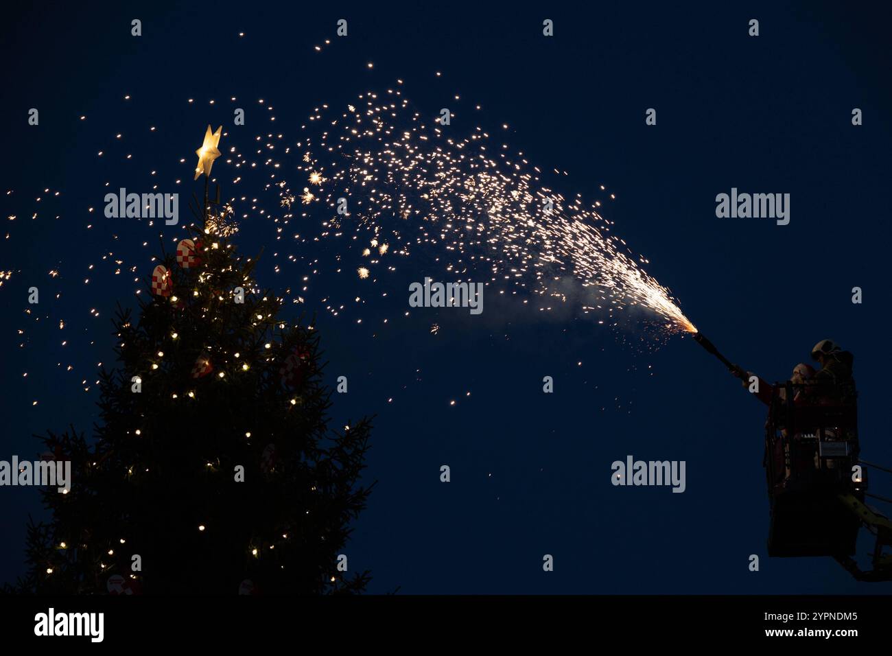 A man dressed as Santa Claus lights a Christmas tree on City Hall ...
