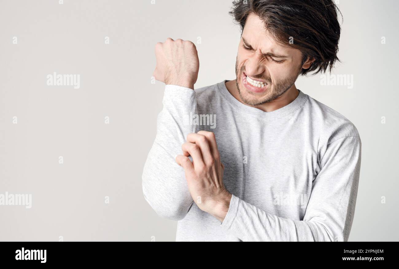 Skin irritation and itching. Man expression of pain, suffers from ...