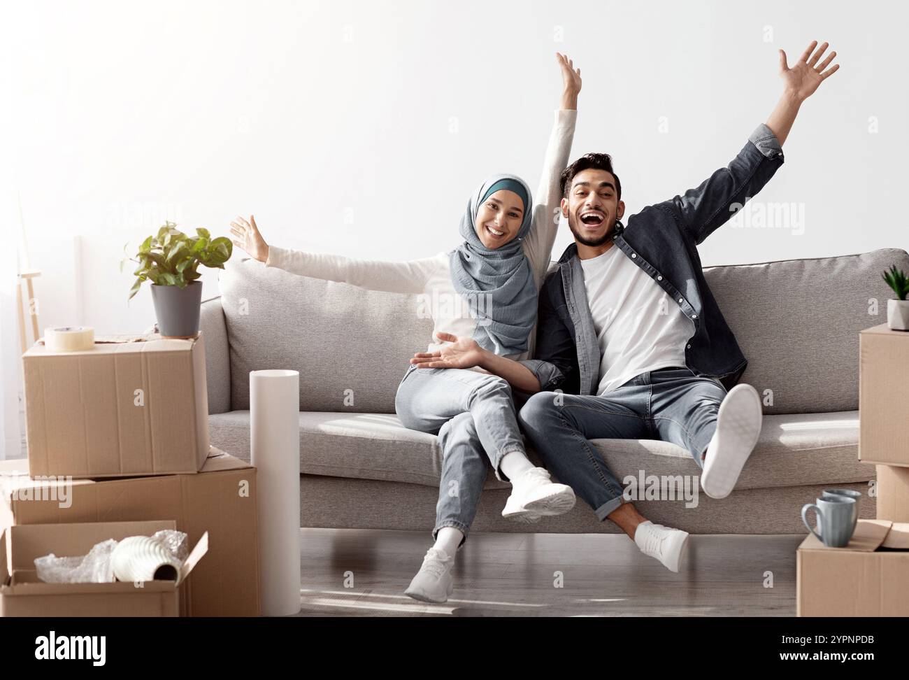 Emotional muslim family celebrating moving to their new house Stock ...