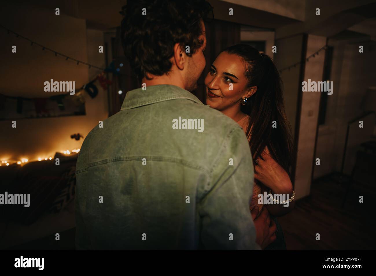 Romantic couple celebrating a birthday at cozy indoor party Stock Photo ...