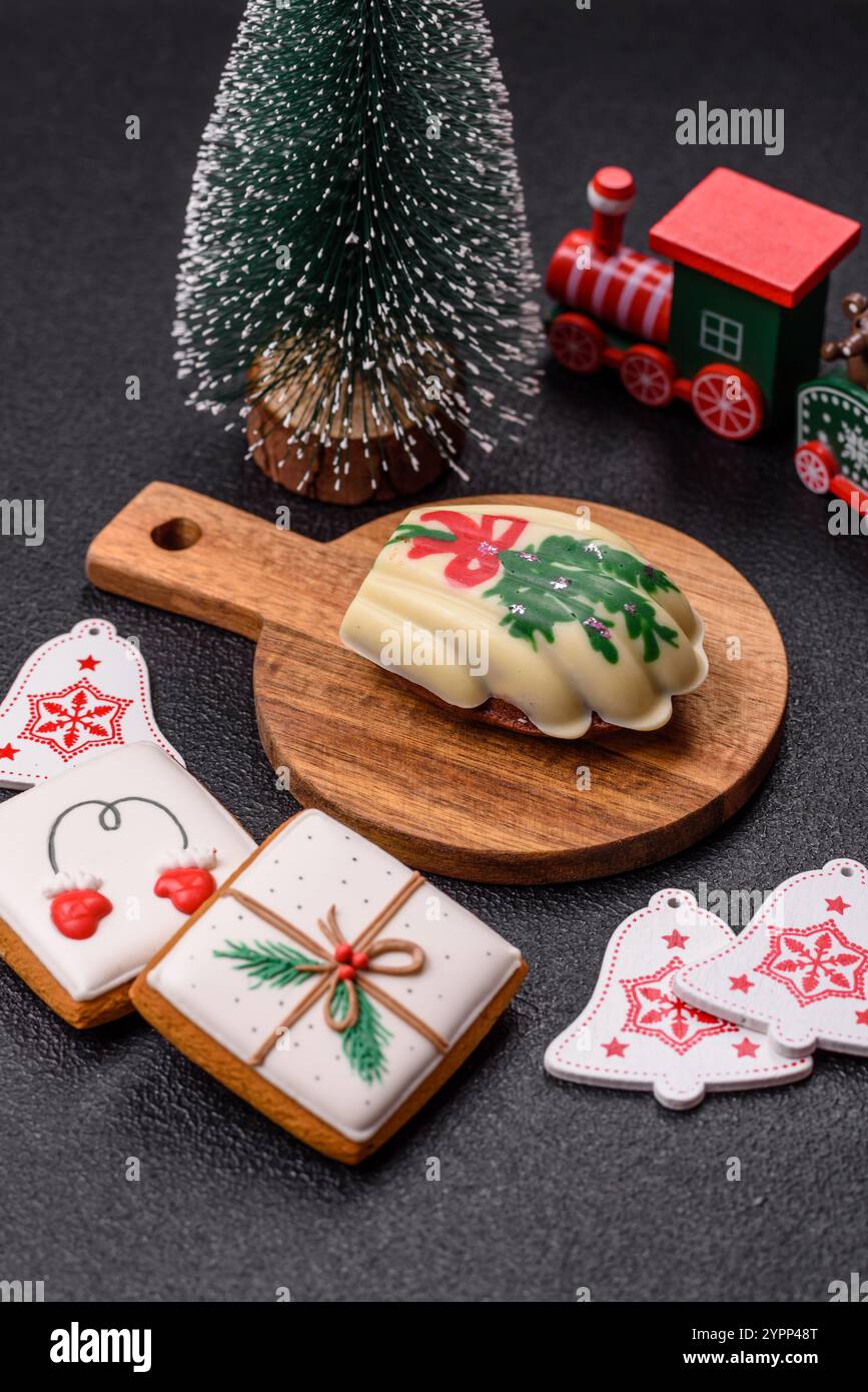 Sweet madeleine sponge cookies covered with colored chocolate in a ...