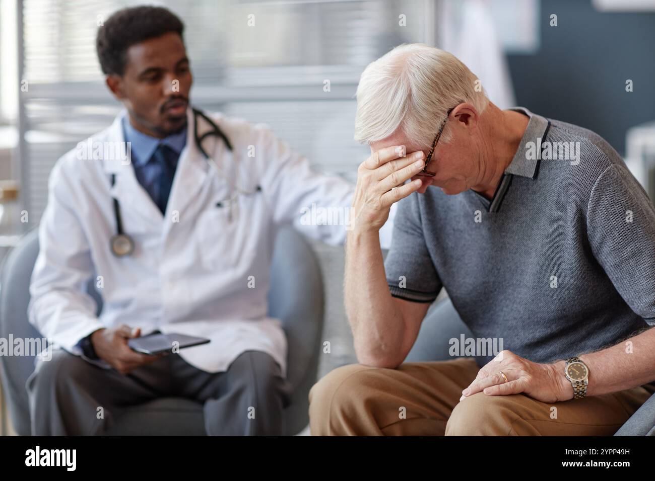 Side view portrait of senior man crying during consultation at clinic ...