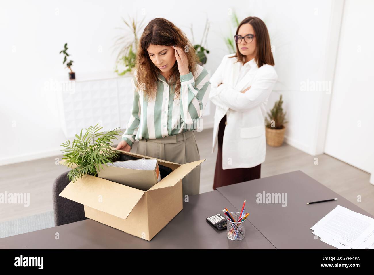 Caucasian women in corporate office facing challenges with packing ...