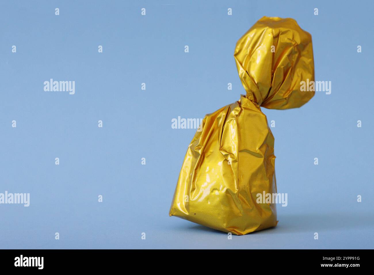 Chocolate candy wrapped in yellow and gold foil. Yellow elite chocolate ...