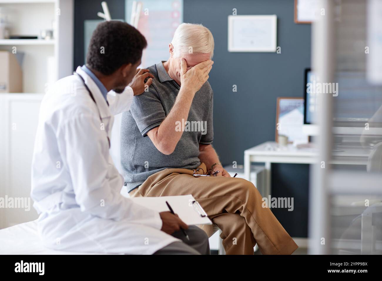 Candid scene with Caucasian senior man crying during consultation in ...