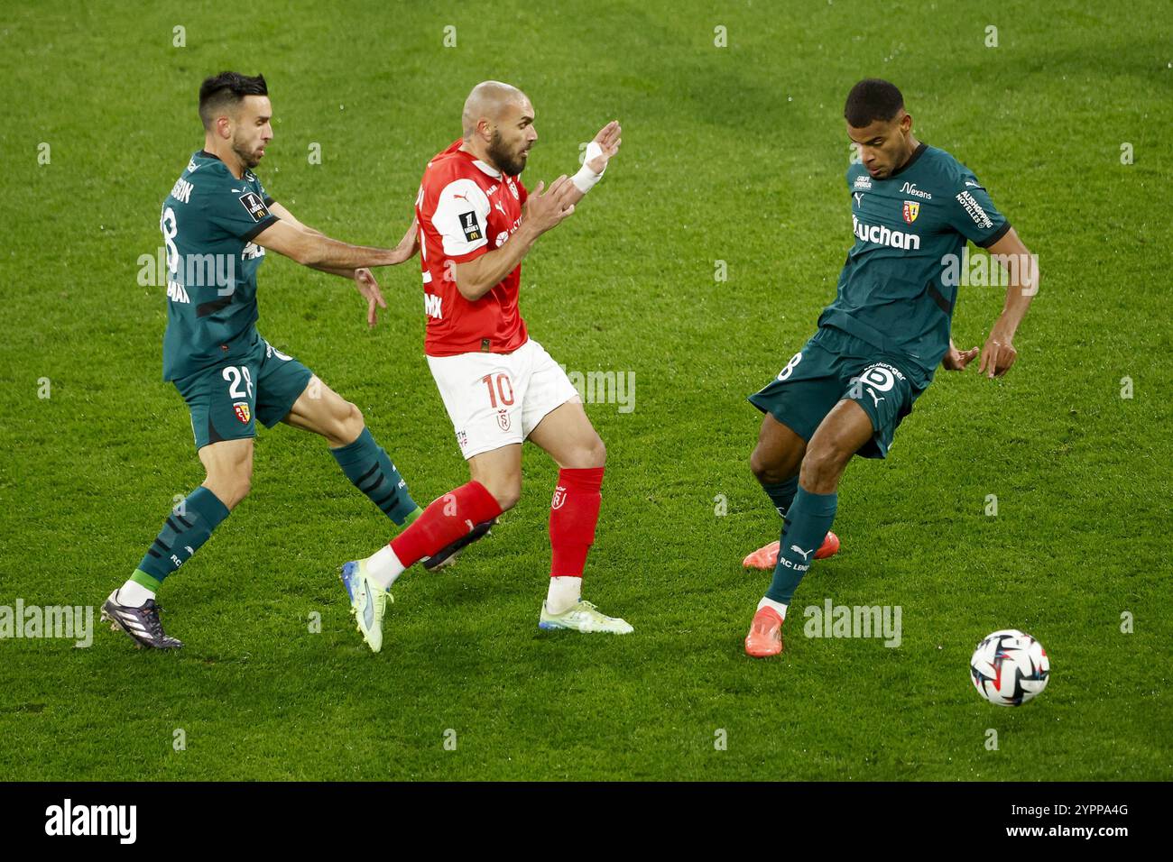 Teddy Teuma of Reims between Adrien Thomasson and Andy Diouf of Lens ...