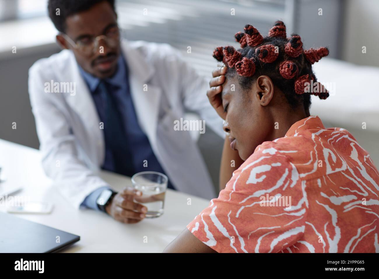 Side view of frustrated African American woman as female patient crying ...