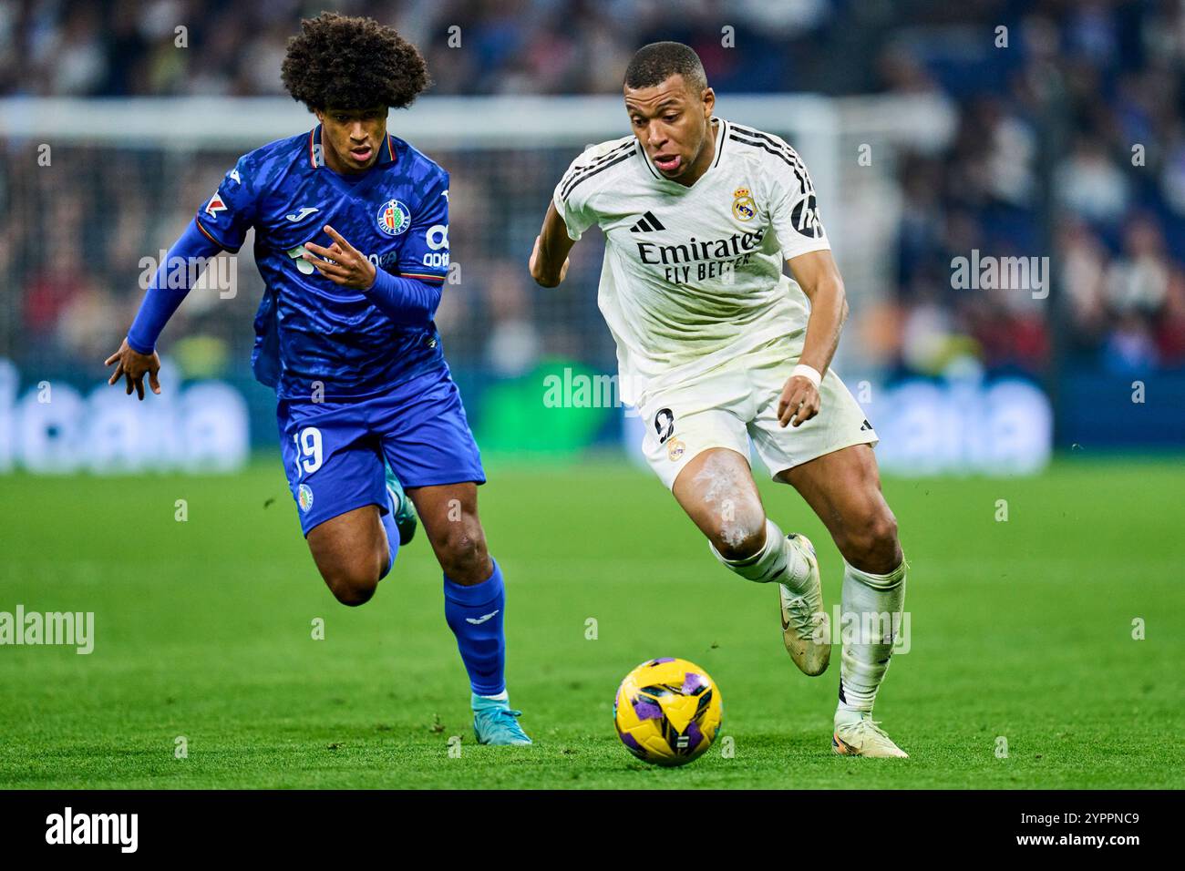 Kylian Mbappe of Real Madrid CF and Peter Federico of Getafe CF during ...
