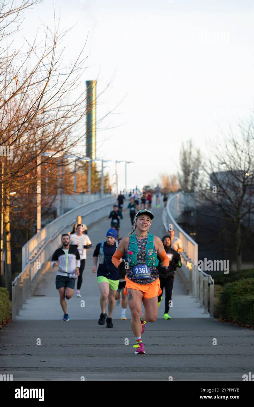 Seattle, Washington, USA. 1st December, 2024. Runners cross the ...