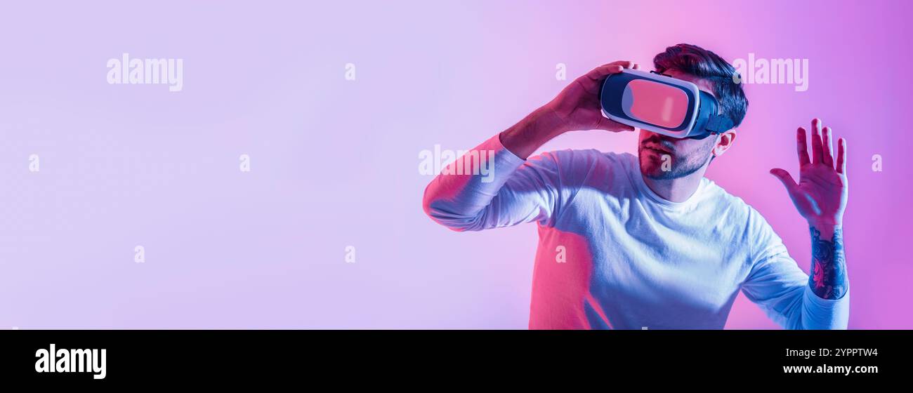 Young man looks virtual reality hi-res stock photography and images - Alamy