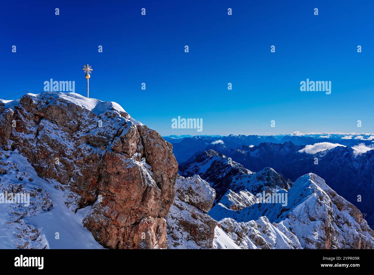 View of the summit cross on the Zugspitze, the highest mountain peak in ...