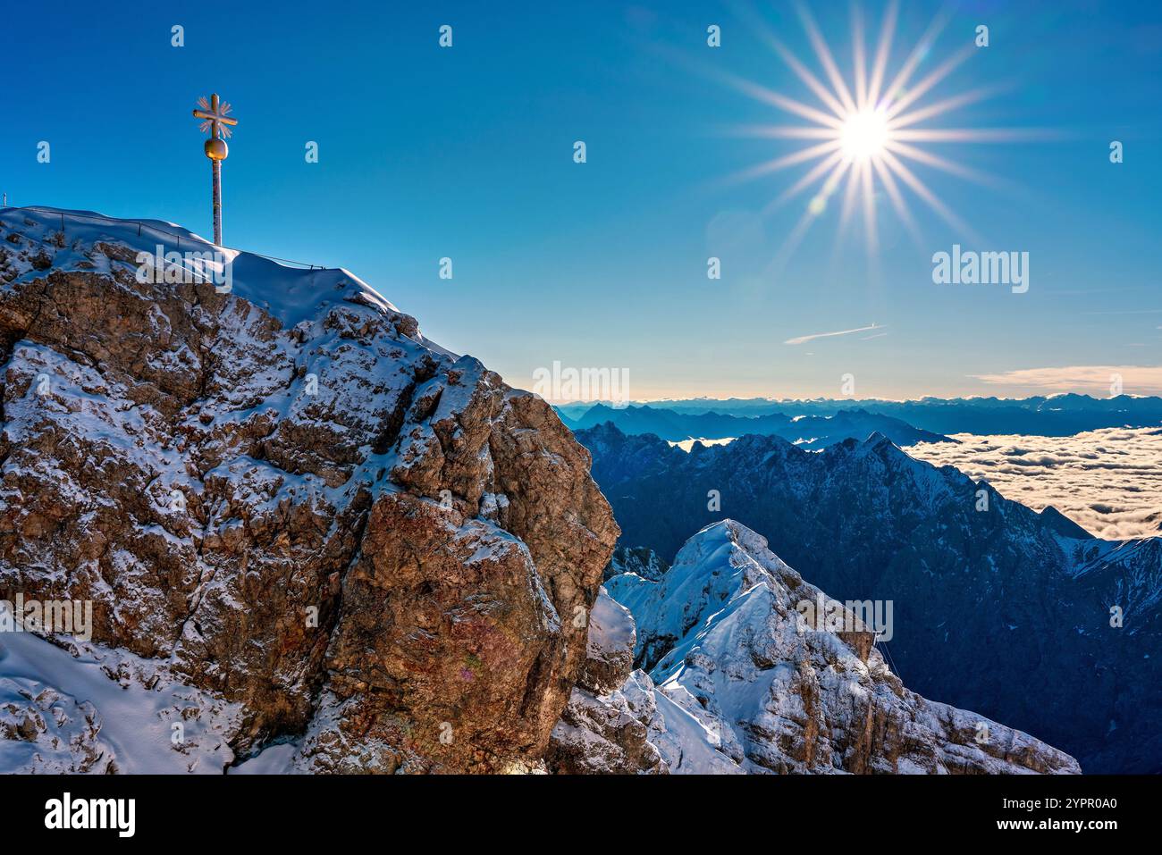 View of the summit cross on the Zugspitze, the highest mountain peak in ...