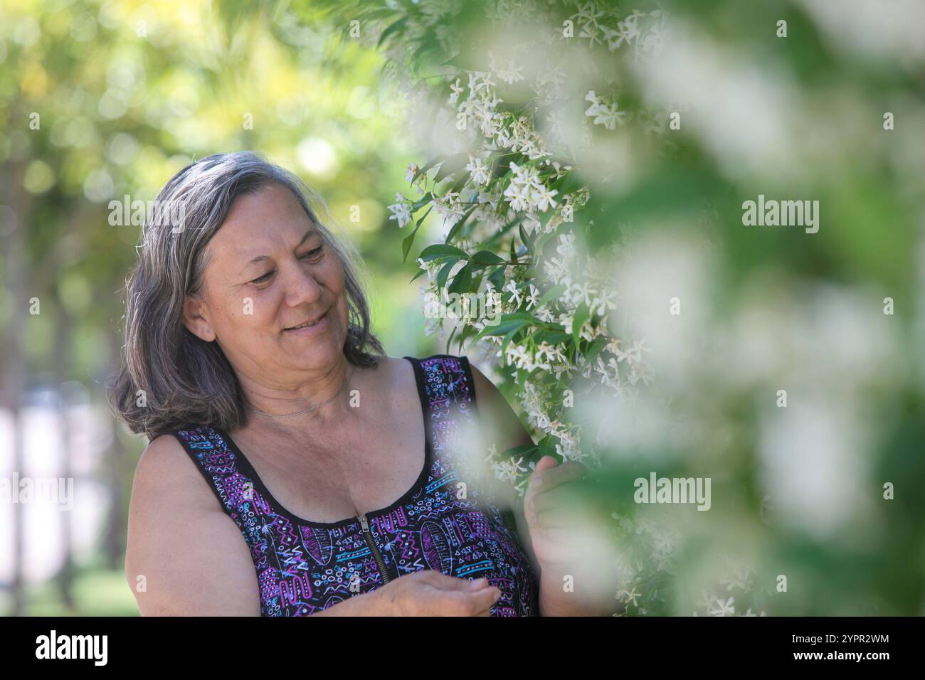 portrait of senior south America native woman in her garden by her ...