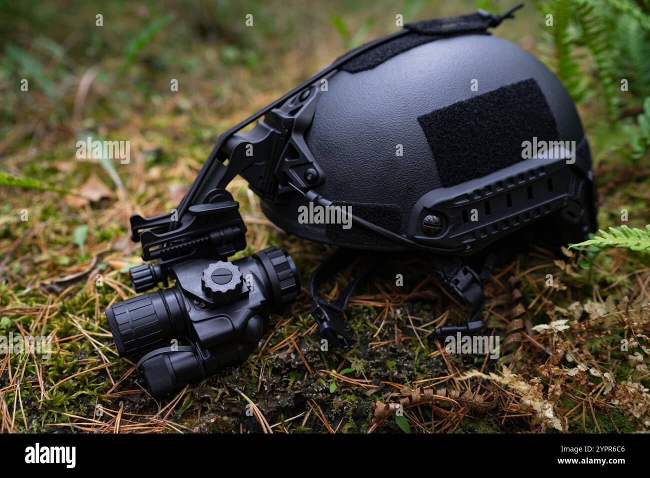 Ballistic helmet with night vision monocular lies on the ground Stock ...