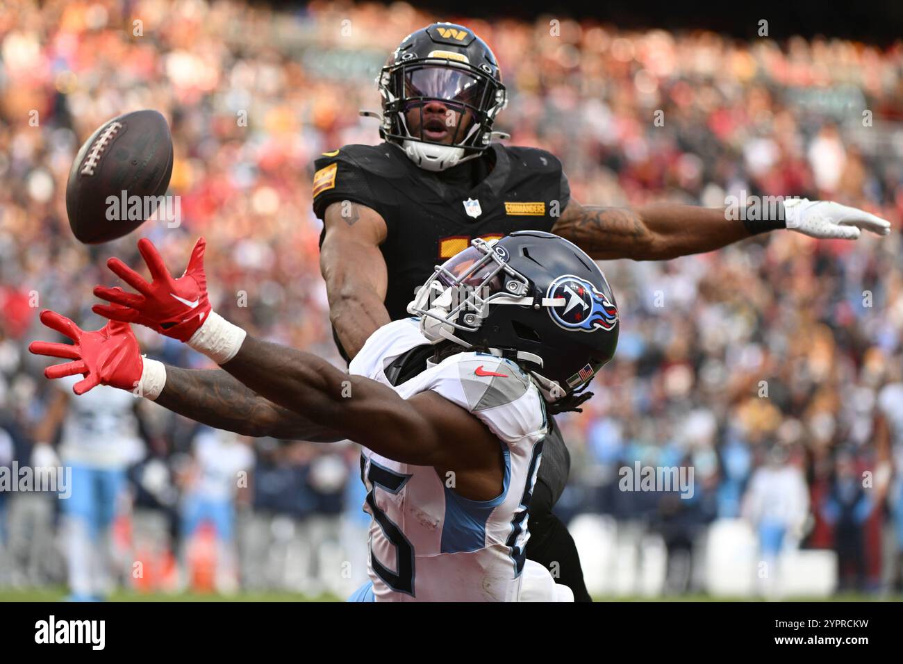 Washington Commanders safety Jeremy Chinn, top, breaks up a pass ...