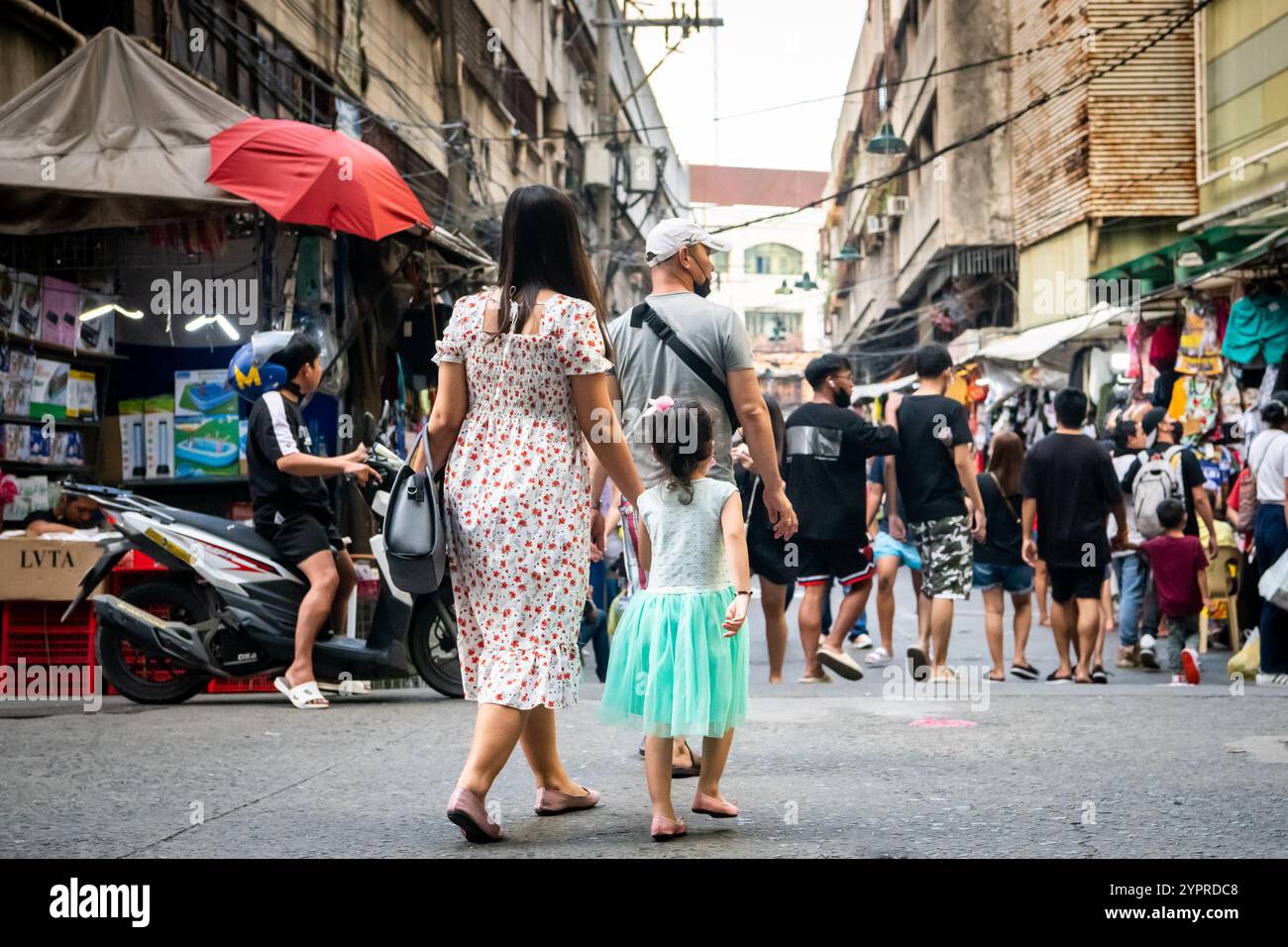 A family makes their way through the busy streets of the China Town ...