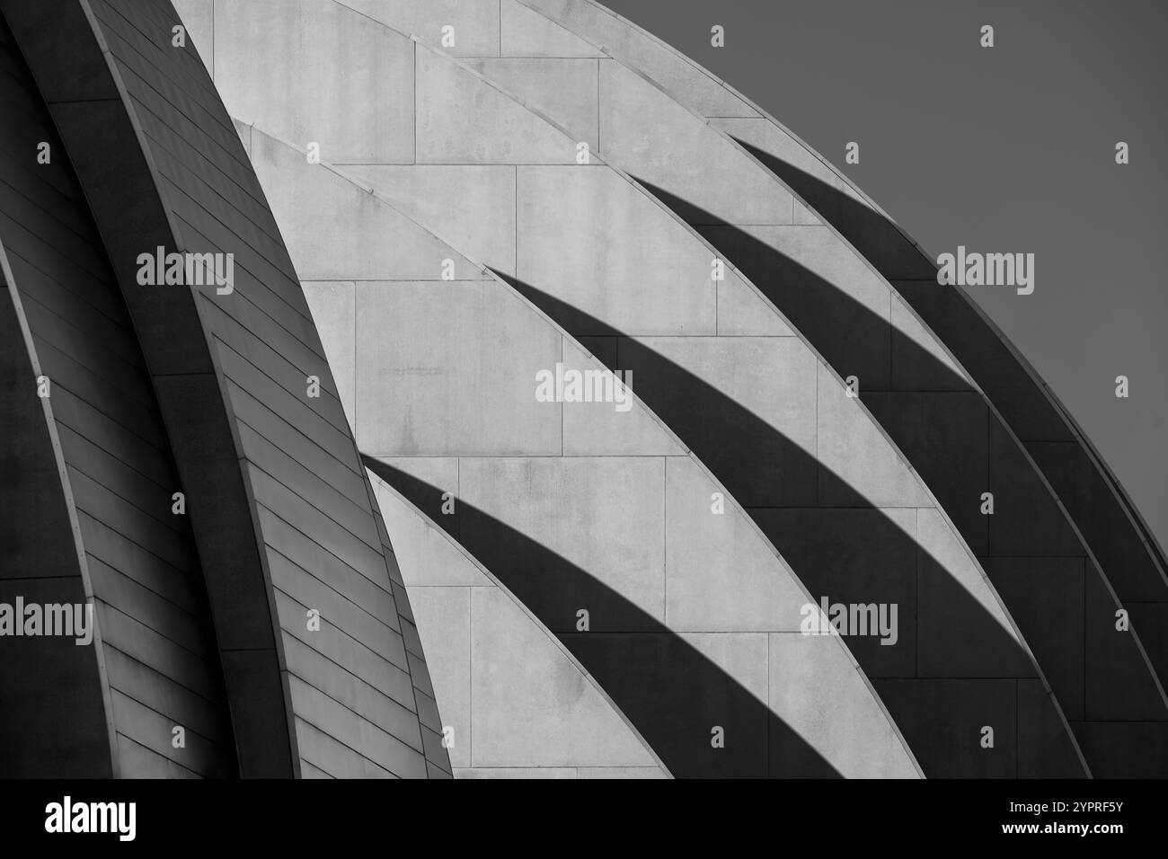 Shadows form abstract curved pattern on the exterior of the modern ...