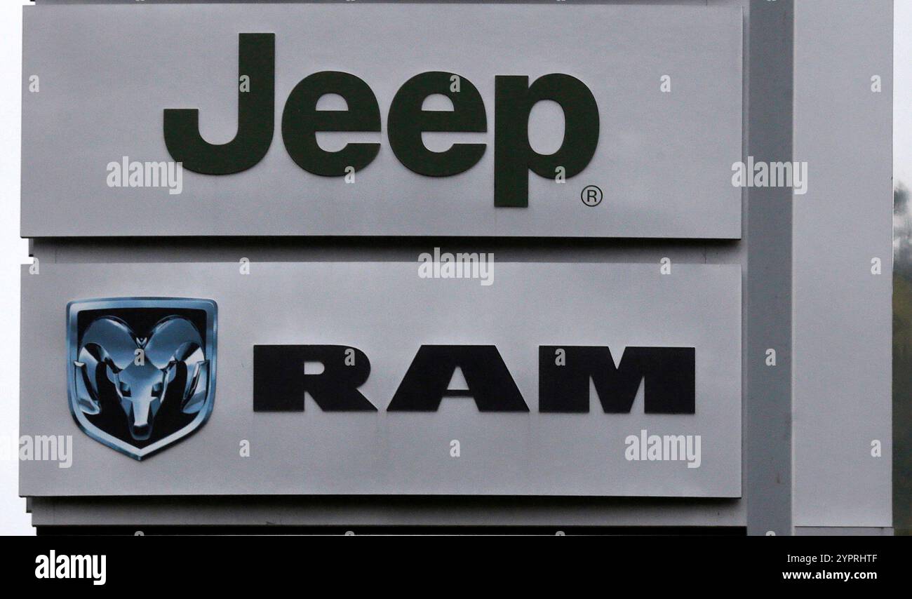 This Oct. 1, 2014 photo shows Jeep and Dodge Ram logos on signs at a ...