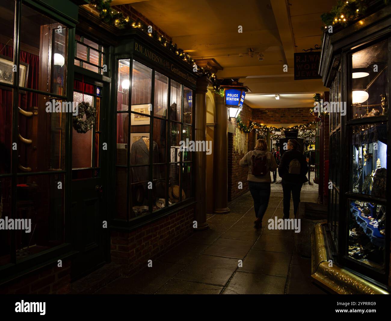 Cozy alleyway illuminated with festive lights and vintage shopfronts ...
