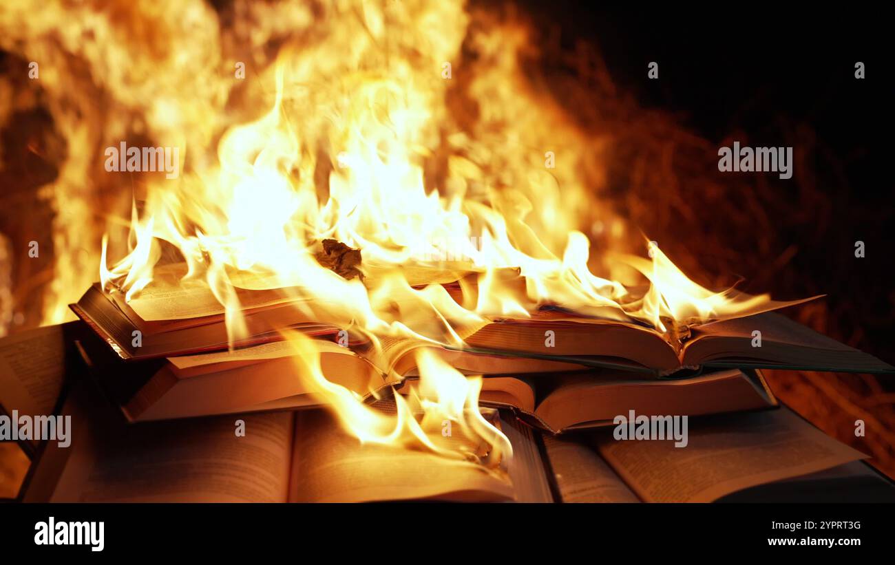 Open book is on fire, pages are engulfed in flames. Concept of ...