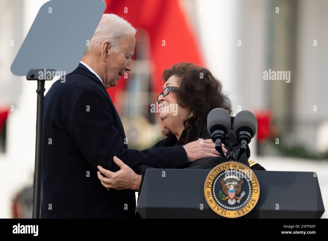President Joe Biden, left, consoles Jeanne White-Ginder, the mother of ...
