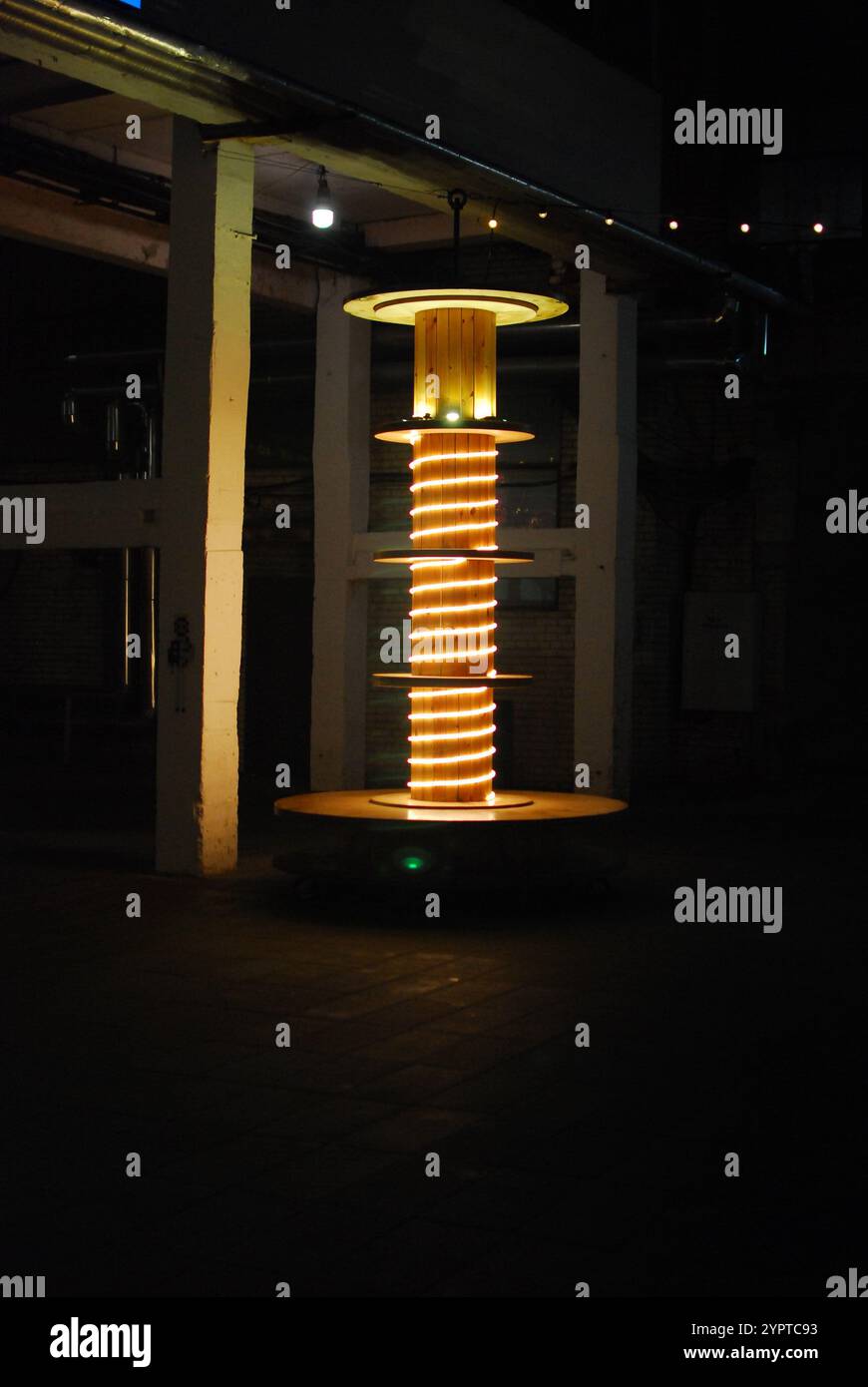 An Illuminated High Voltage Coil art piece shown in a dark setting with ...