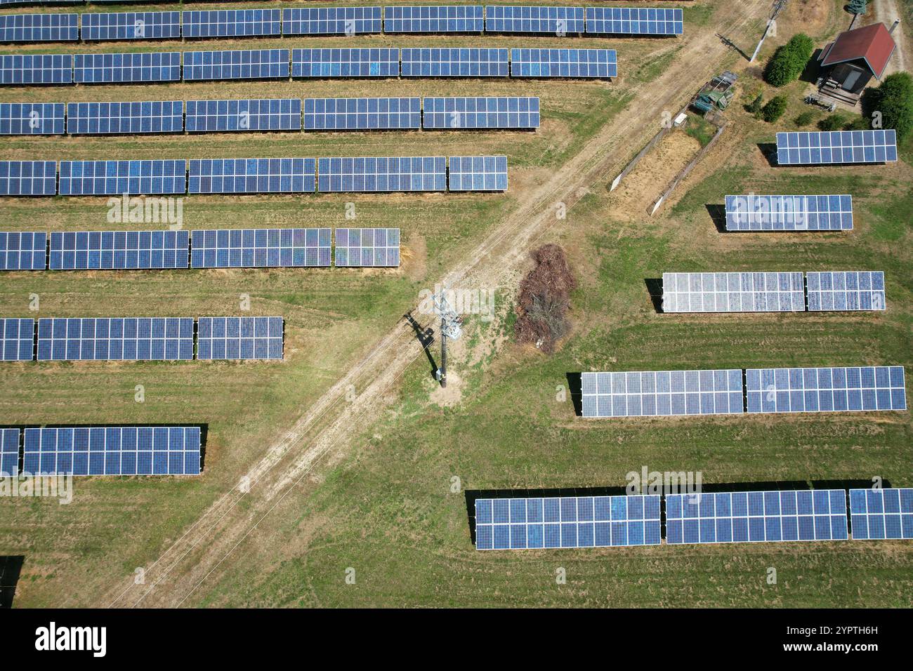 Aerial photo of solar power plant. Many solar energy panels in countryside from above ...