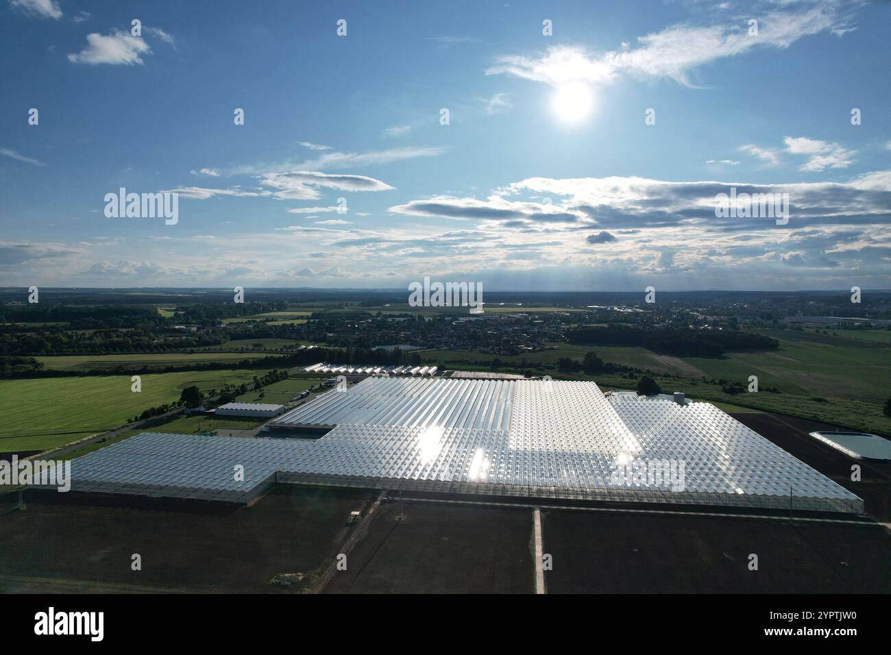Glass greenhouses from above in sunny weather, big glass houses from ...
