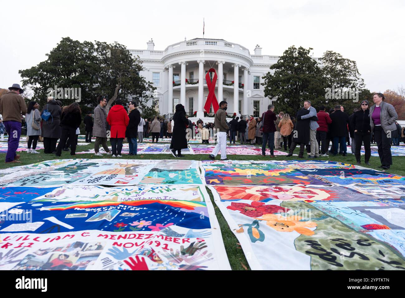 AIDS survivors, their families and advocates look at the display of ...