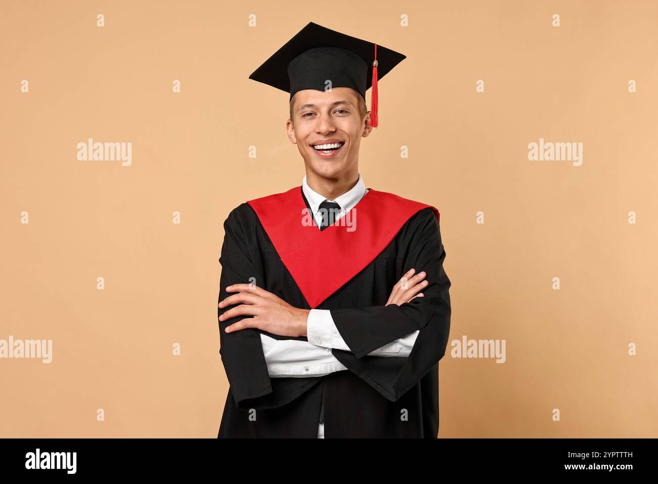 Graduate man confident arms crossed hi-res stock photography and images ...