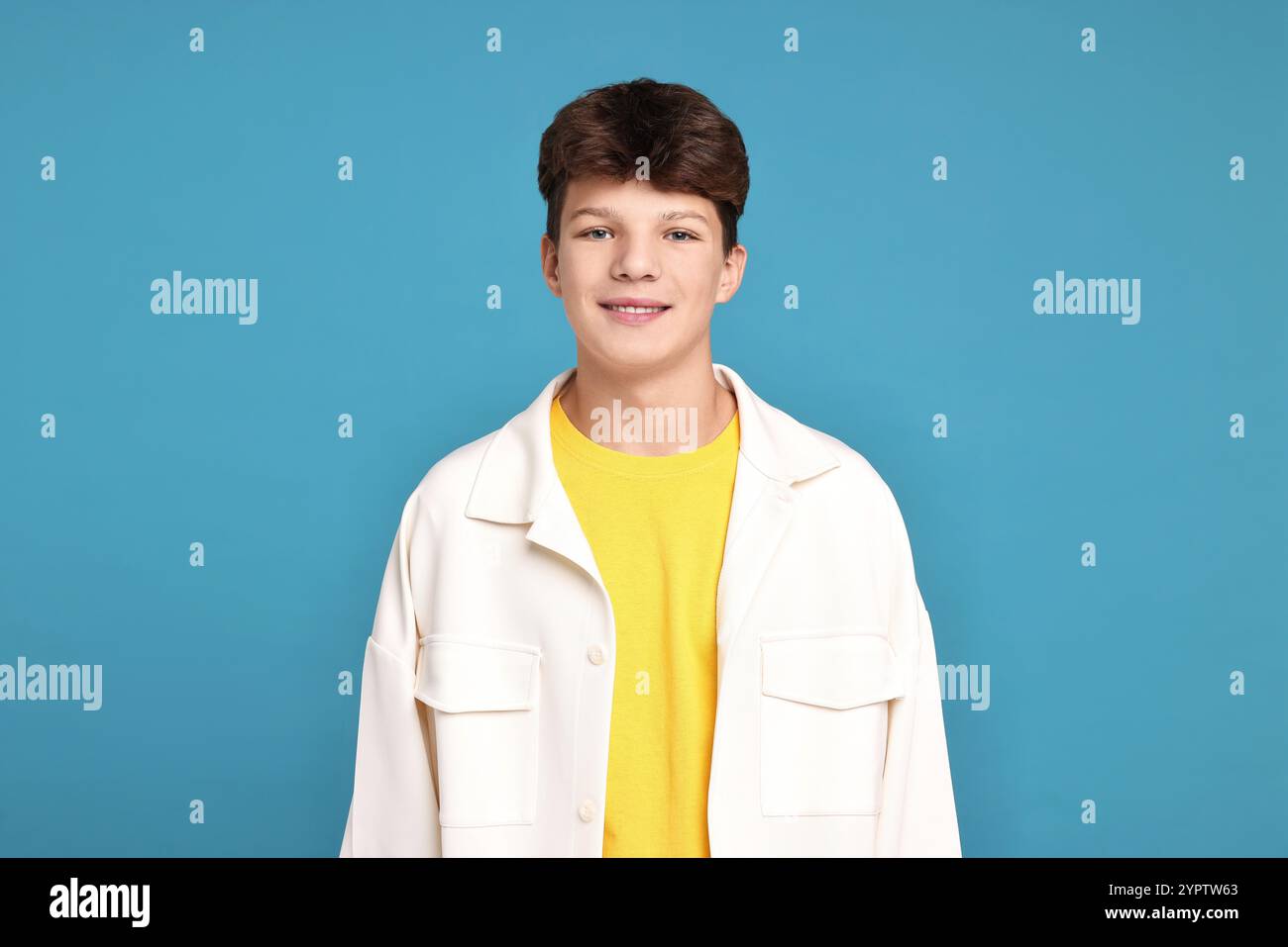 Portrait of teenage boy on light blue background Stock Photo - Alamy