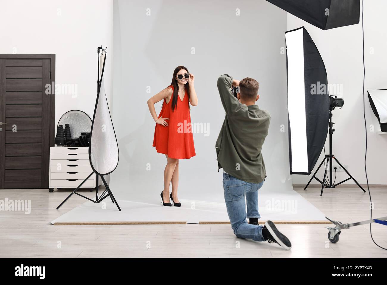 Photographer working with model in professional photo studio Stock ...