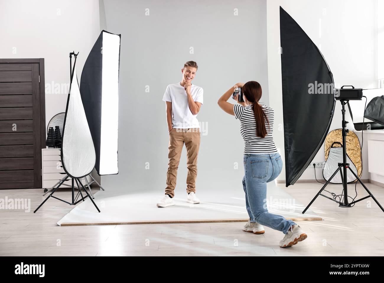 Photographer working with model in professional photo studio Stock ...