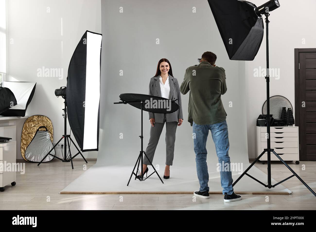 Photographer working with model in professional photo studio Stock ...