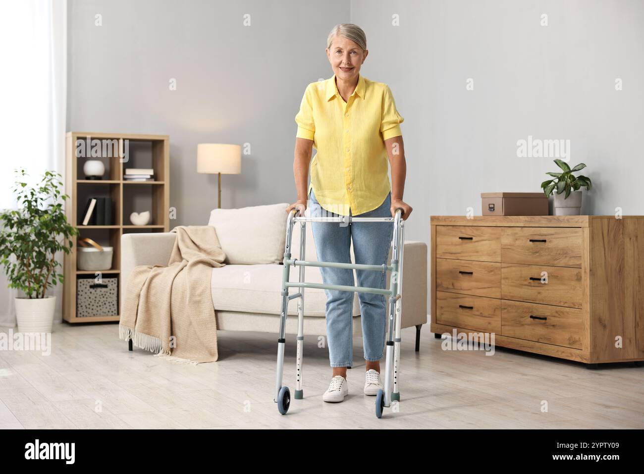Senior woman with walking frame at home Stock Photo - Alamy