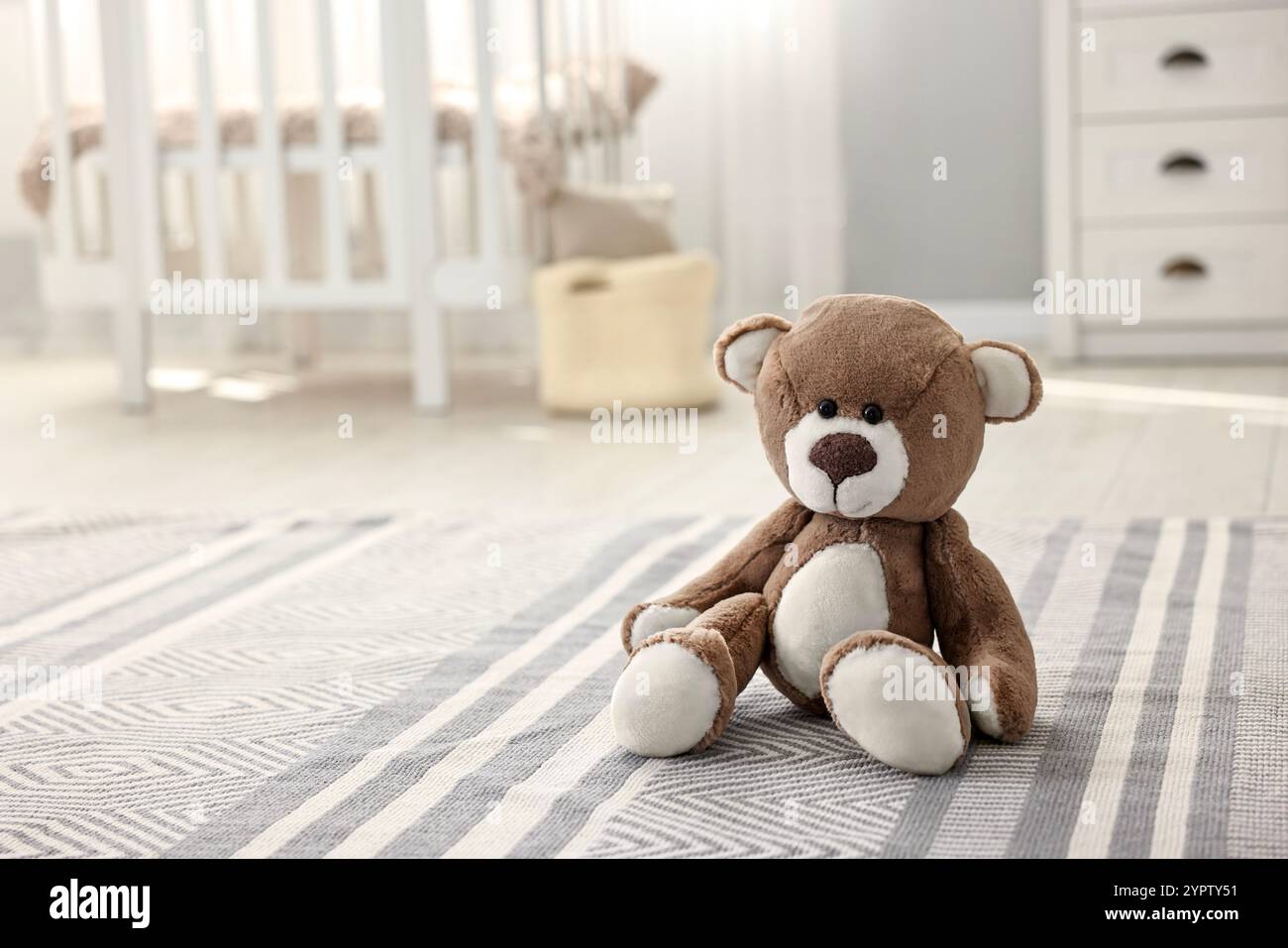 Cute teddy bear on floor in child room, space for text Stock Photo - Alamy