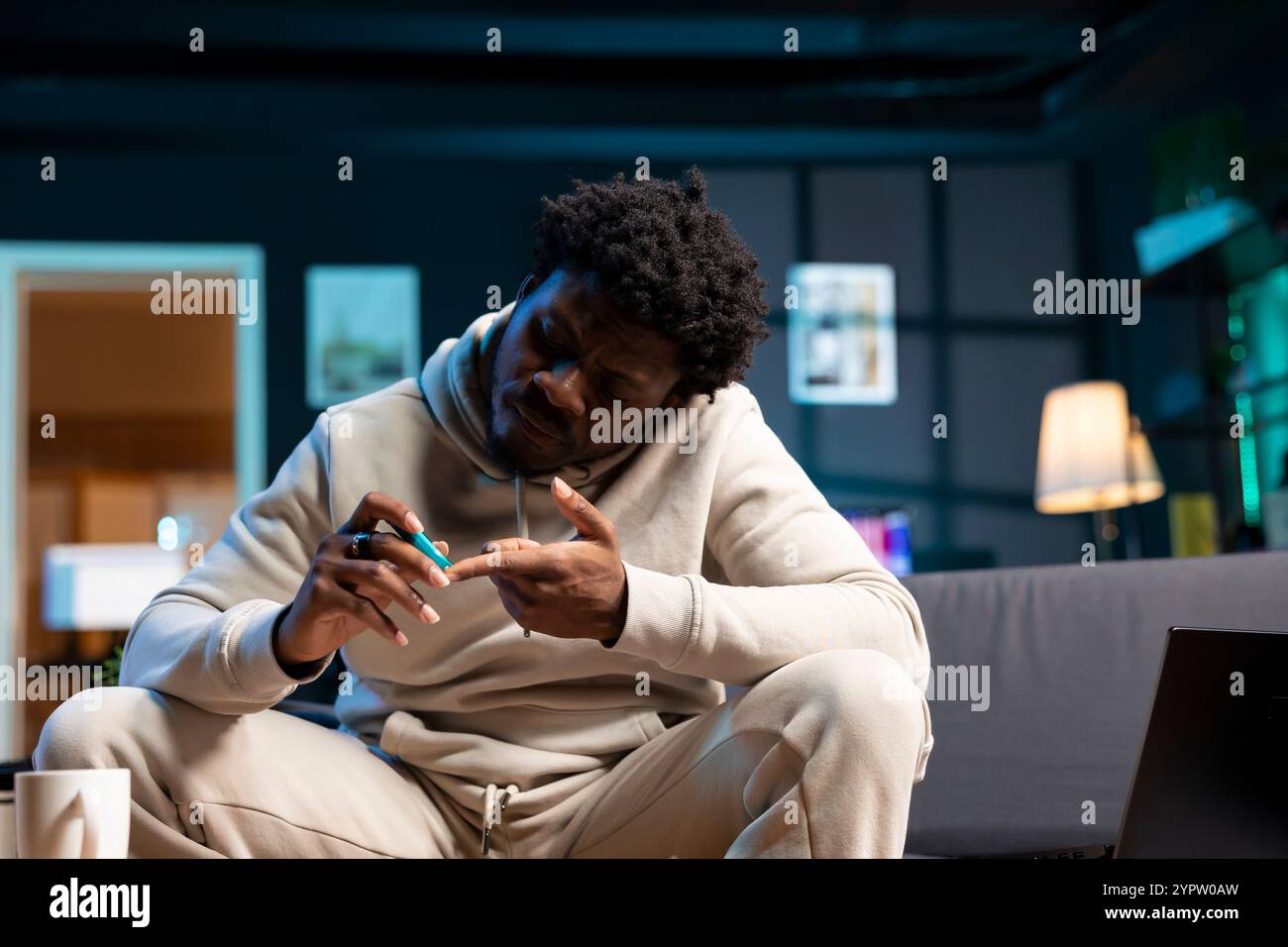 BIPOC person clipping own finger using pulse oximeter, examining level ...